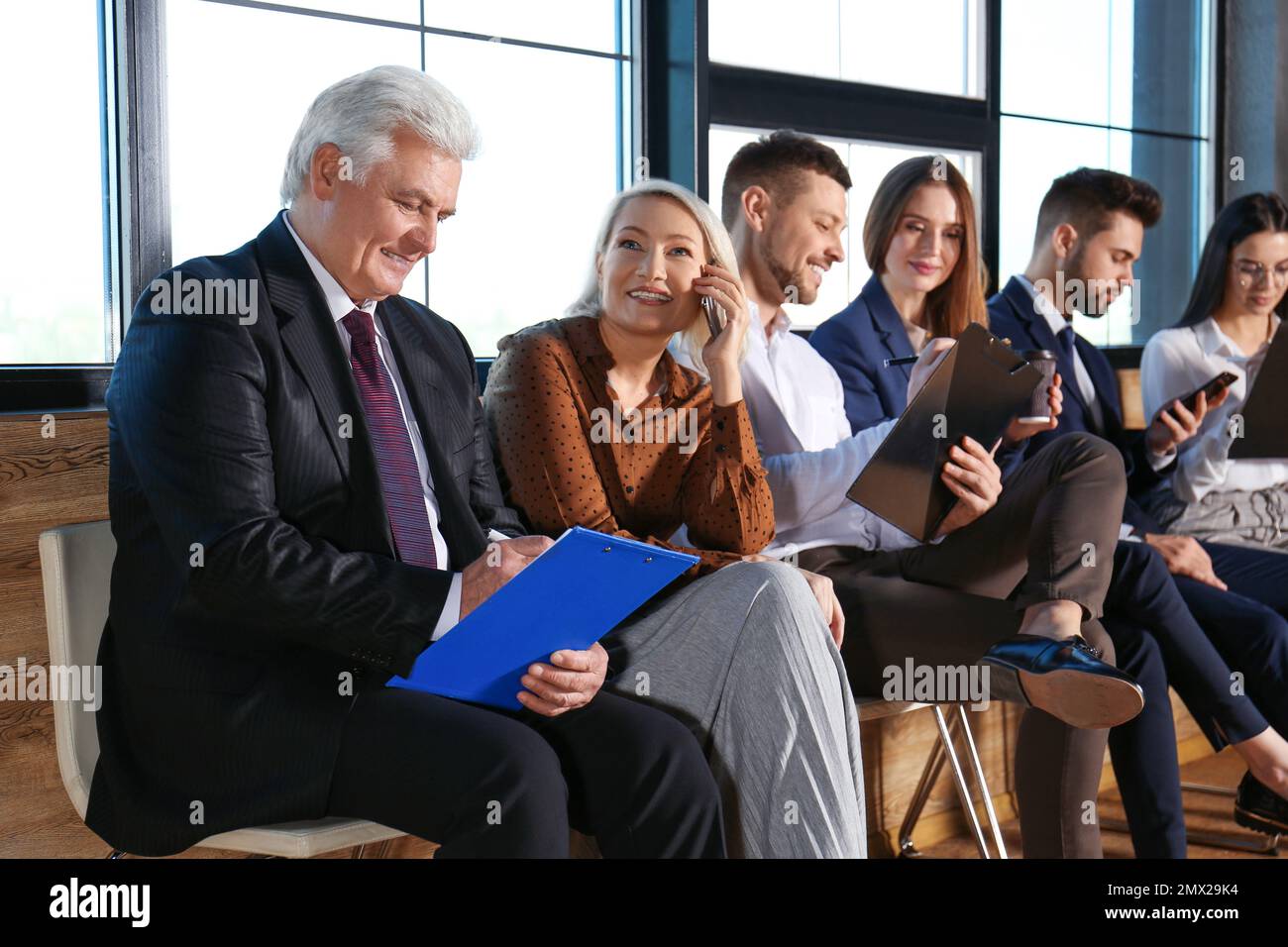 People waiting for job interview in office hall Stock Photo - Alamy
