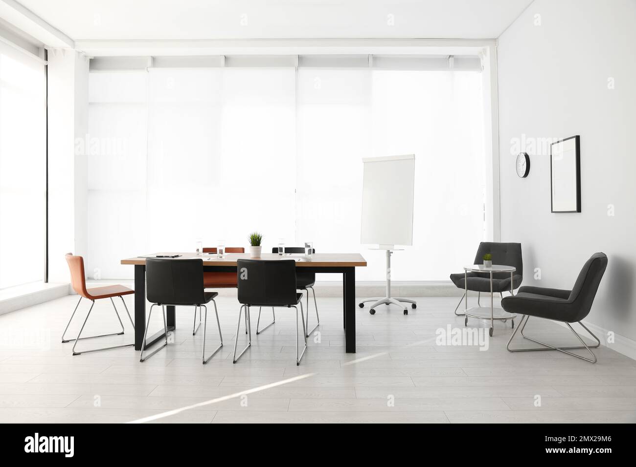 Simple office interior with large table and chairs Stock Photo - Alamy