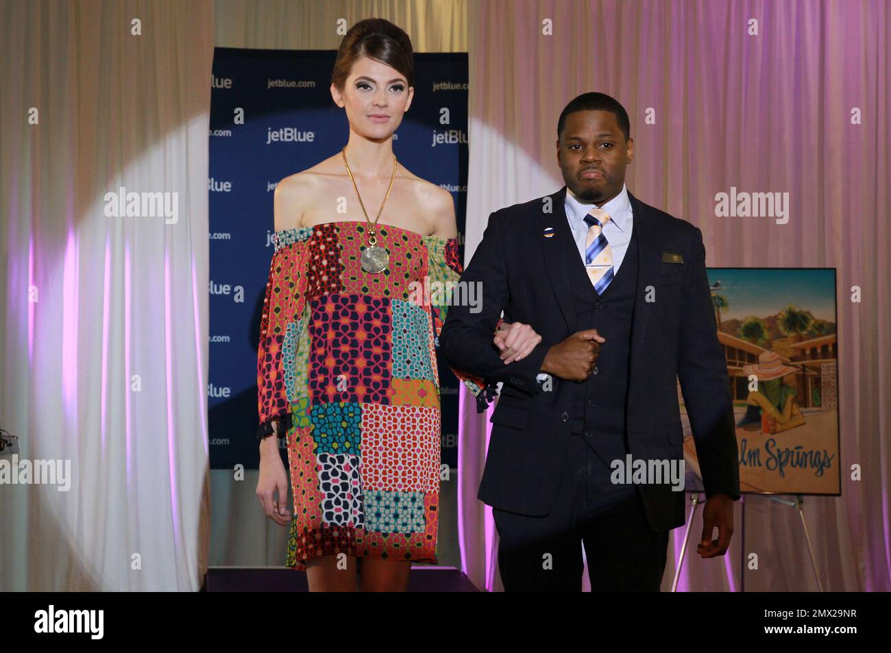 A JetBlue's crew member and model wearing Trina Turik designs walks the ...