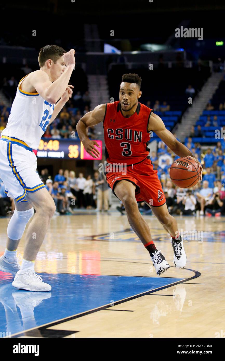 Cal State Northridge guard Darin Johnson dribbles while UCLA forward TJ ...