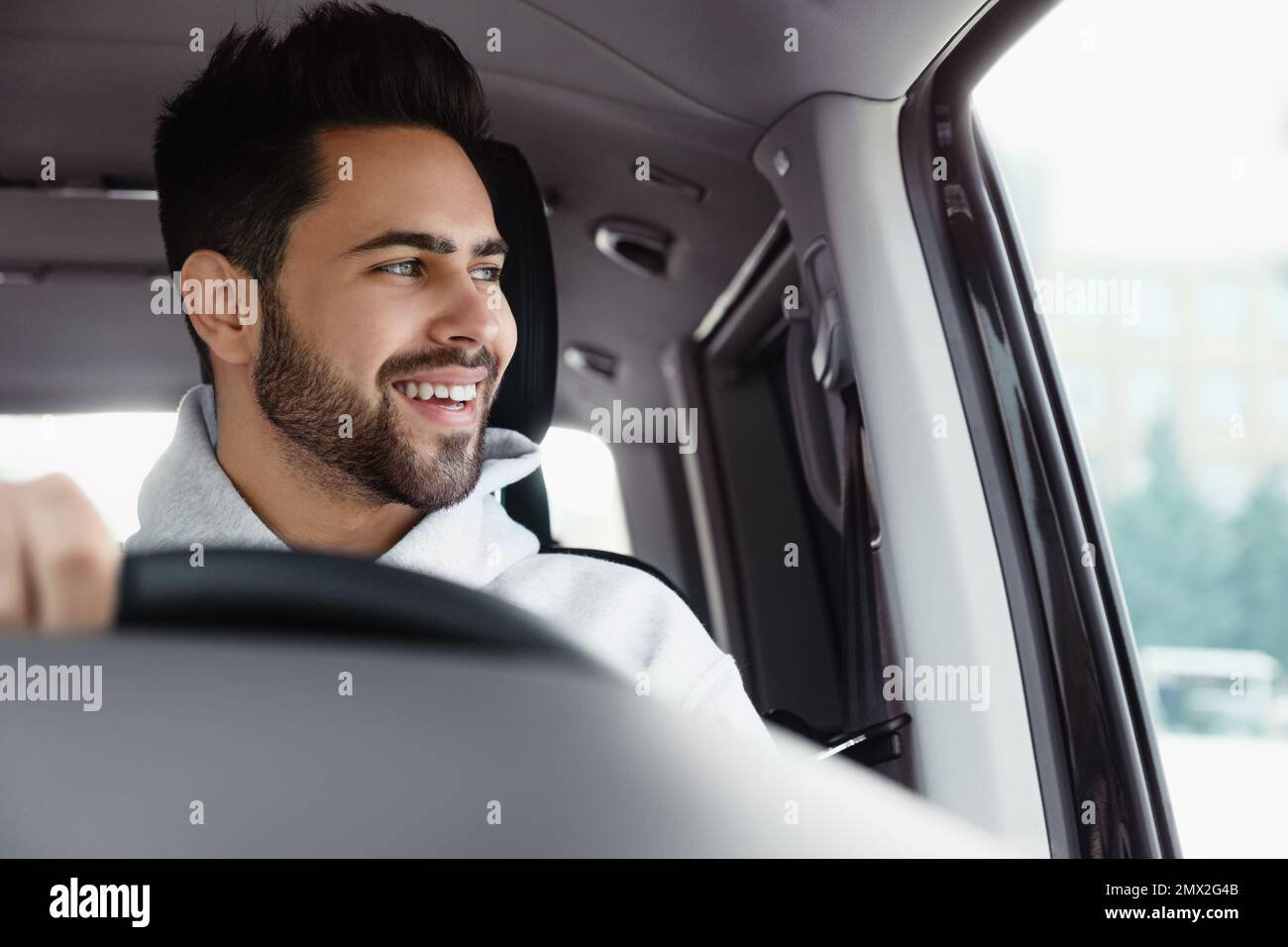 Handsome young man driving hi-res stock photography and images - Alamy