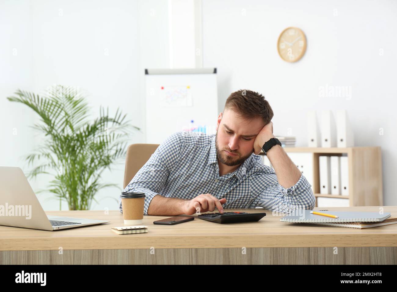 Lazy young office employee procrastinating at workplace Stock Photo - Alamy