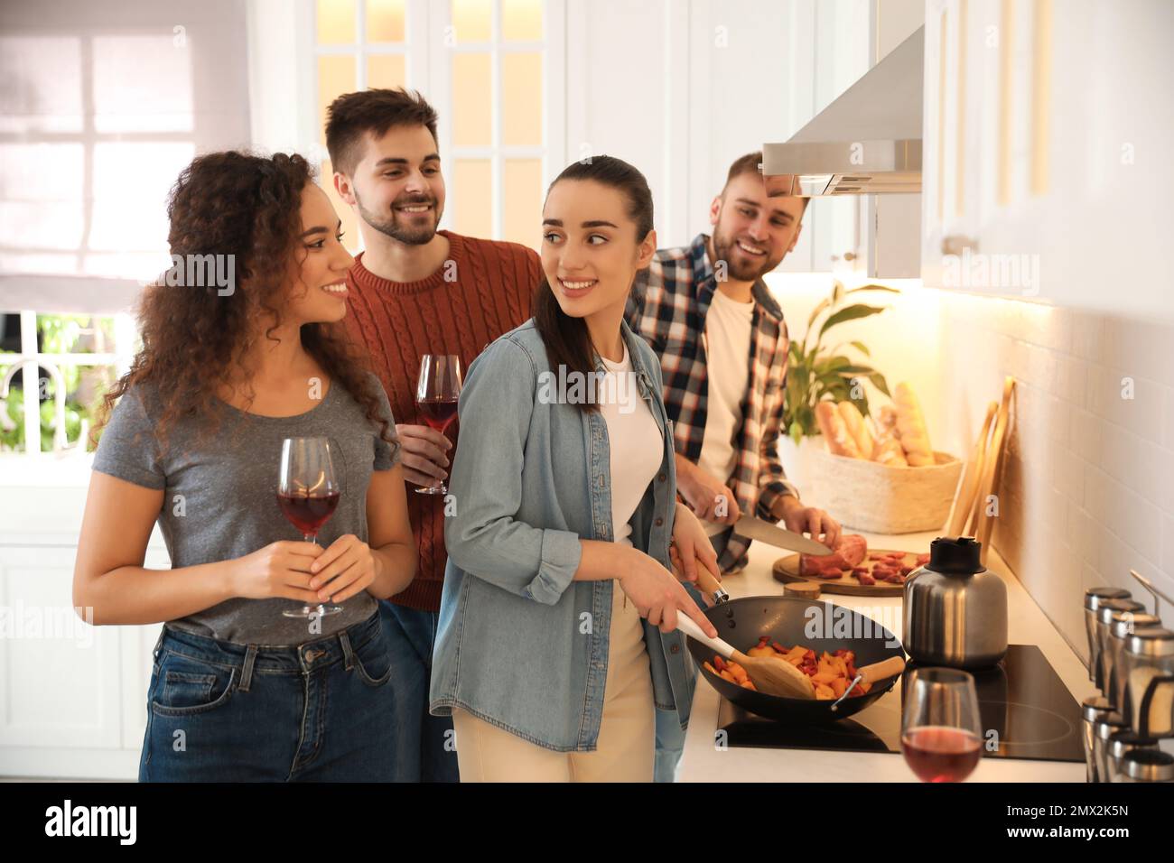 Happy people cooking food together in kitchen Stock Photo - Alamy