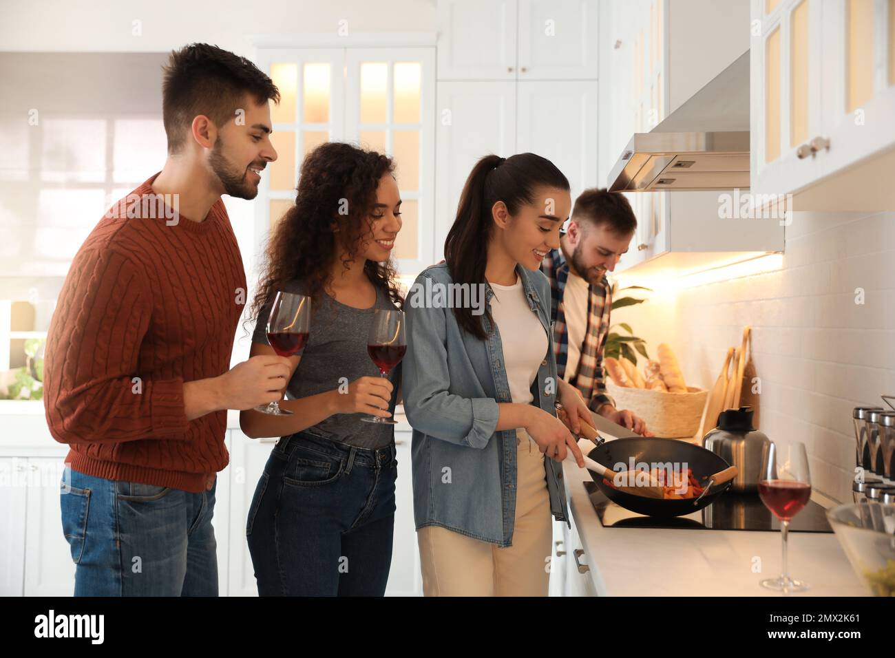 Happy people cooking food together in kitchen Stock Photo - Alamy