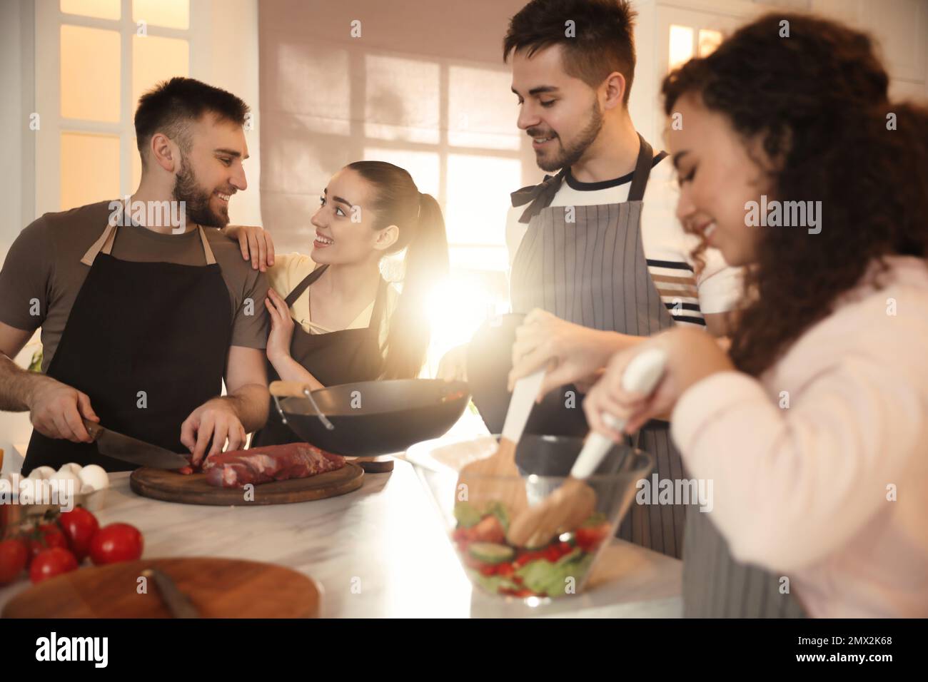 Happy people cooking food together in kitchen Stock Photo - Alamy