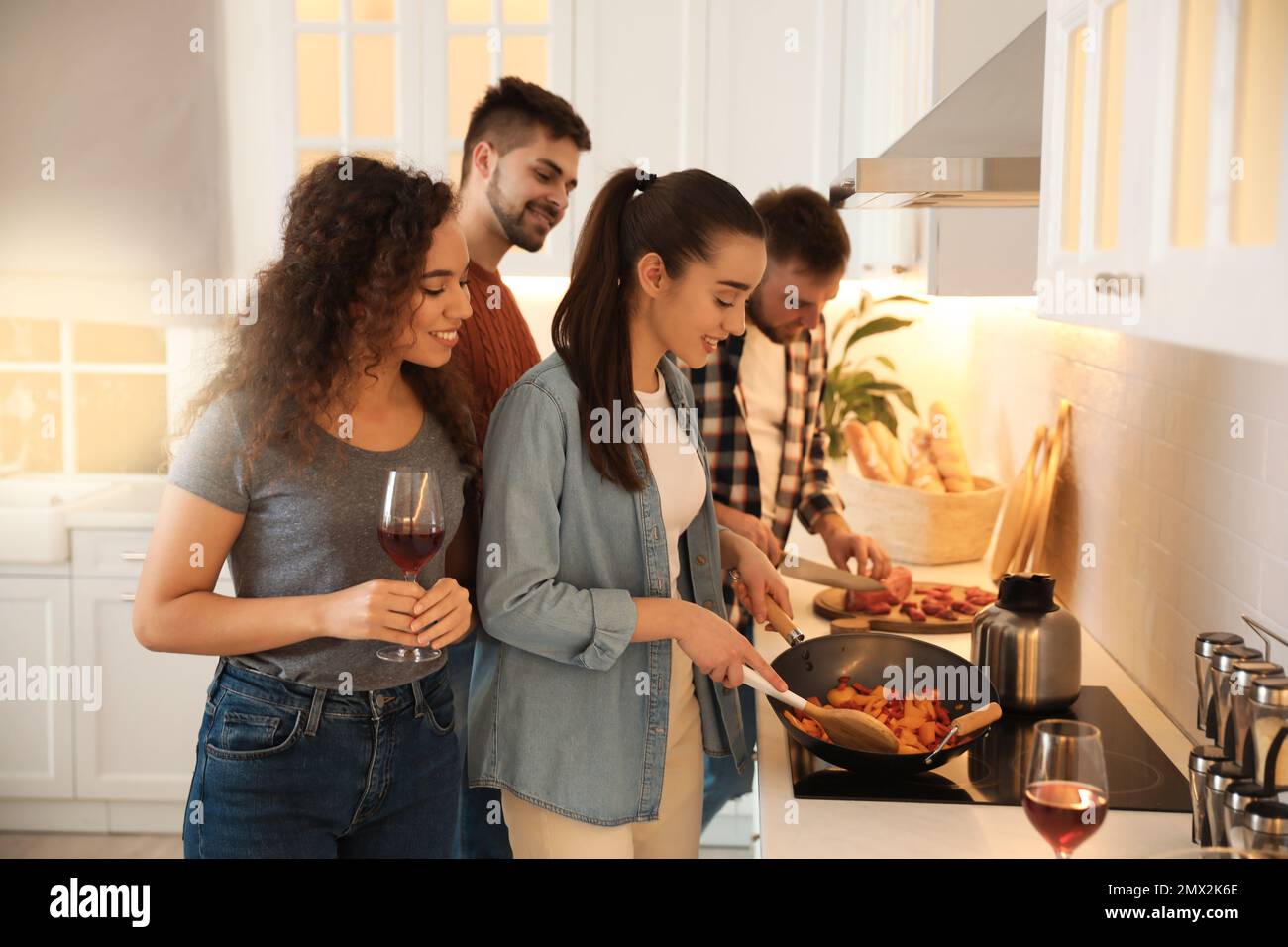 Happy people cooking food together in kitchen Stock Photo - Alamy
