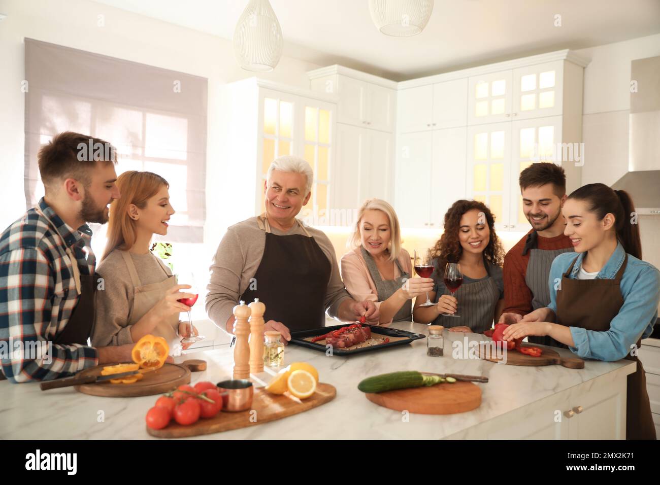 Happy people cooking food together in kitchen Stock Photo - Alamy