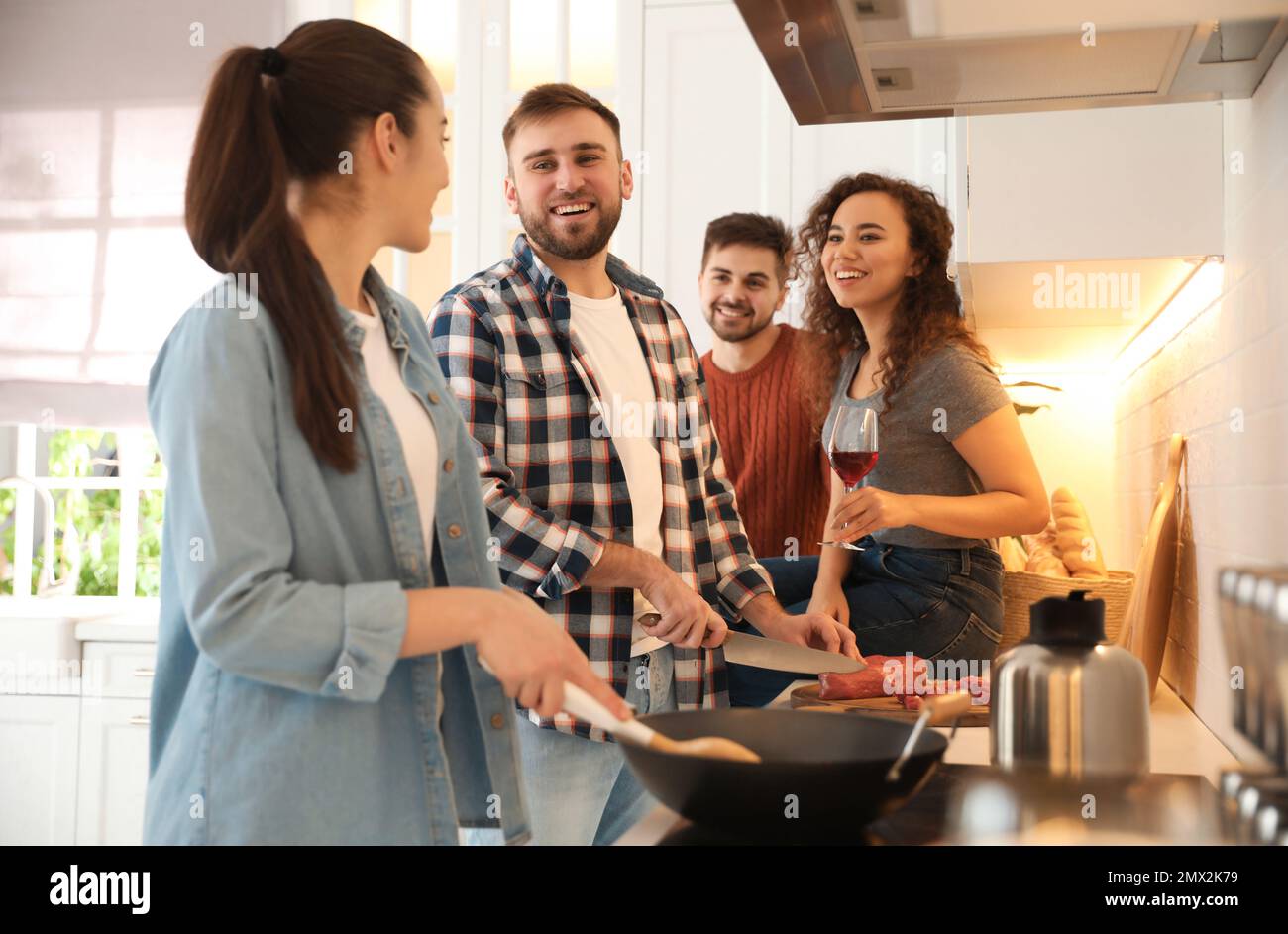 Happy people cooking food together in kitchen Stock Photo - Alamy