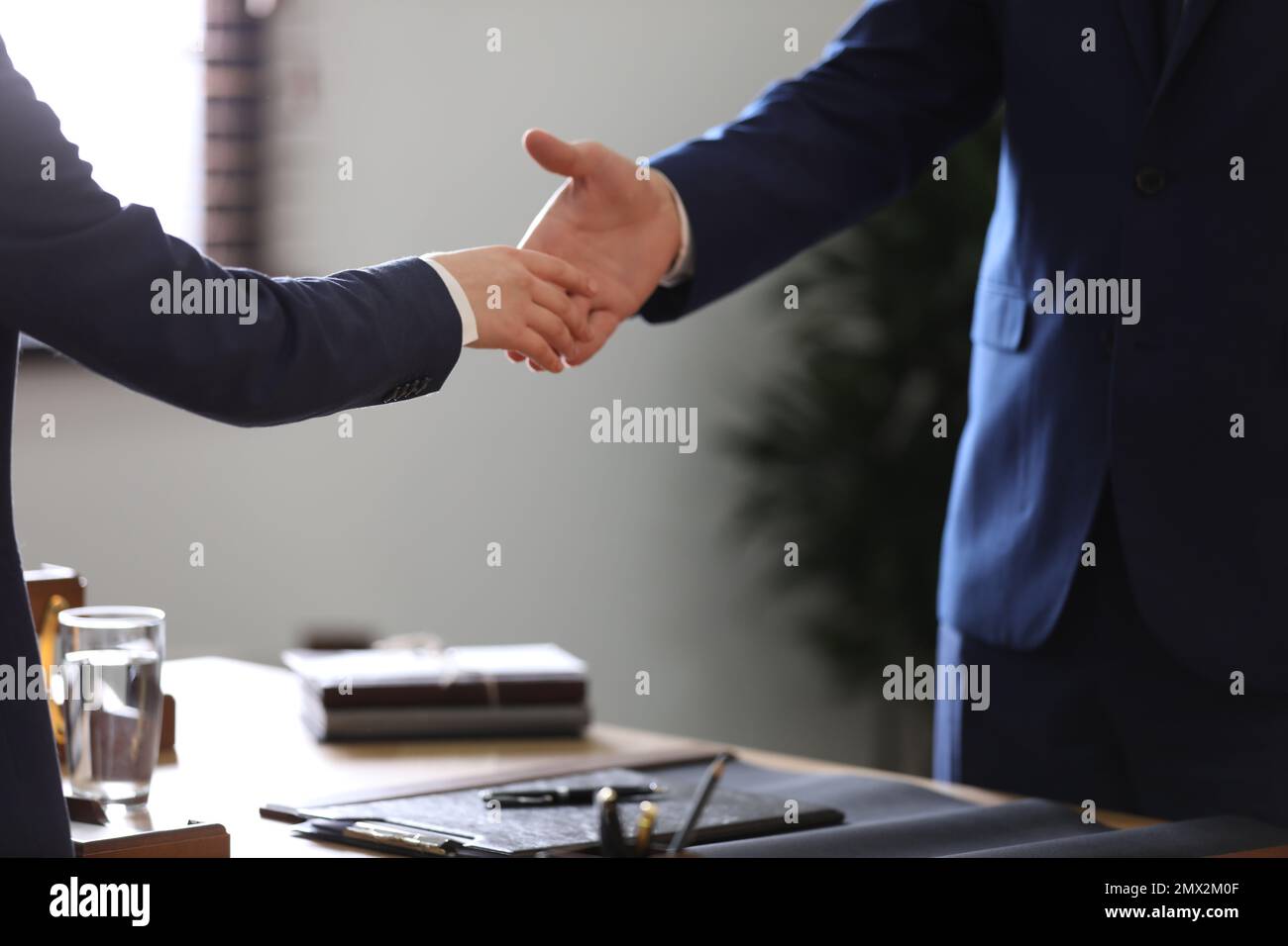 Male lawyer shaking hands with client in office, closeup Stock Photo ...