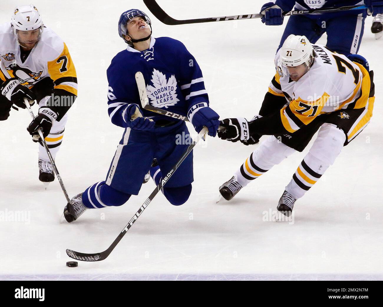 Toronto Maple Leafs' Mitchell Marner gets a high stick in the face by ...