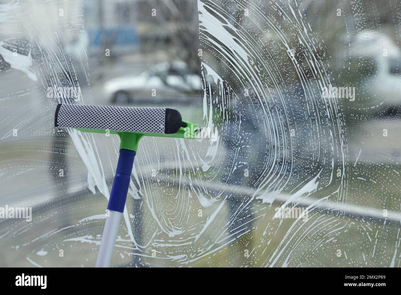 Cleaning window with squeegee indoors. Space for text Stock Photo - Alamy
