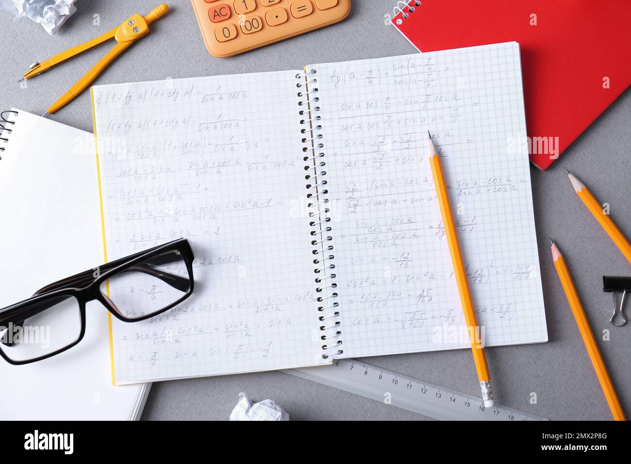 Flat lay composition with open notebook on light grey table. Doing ...