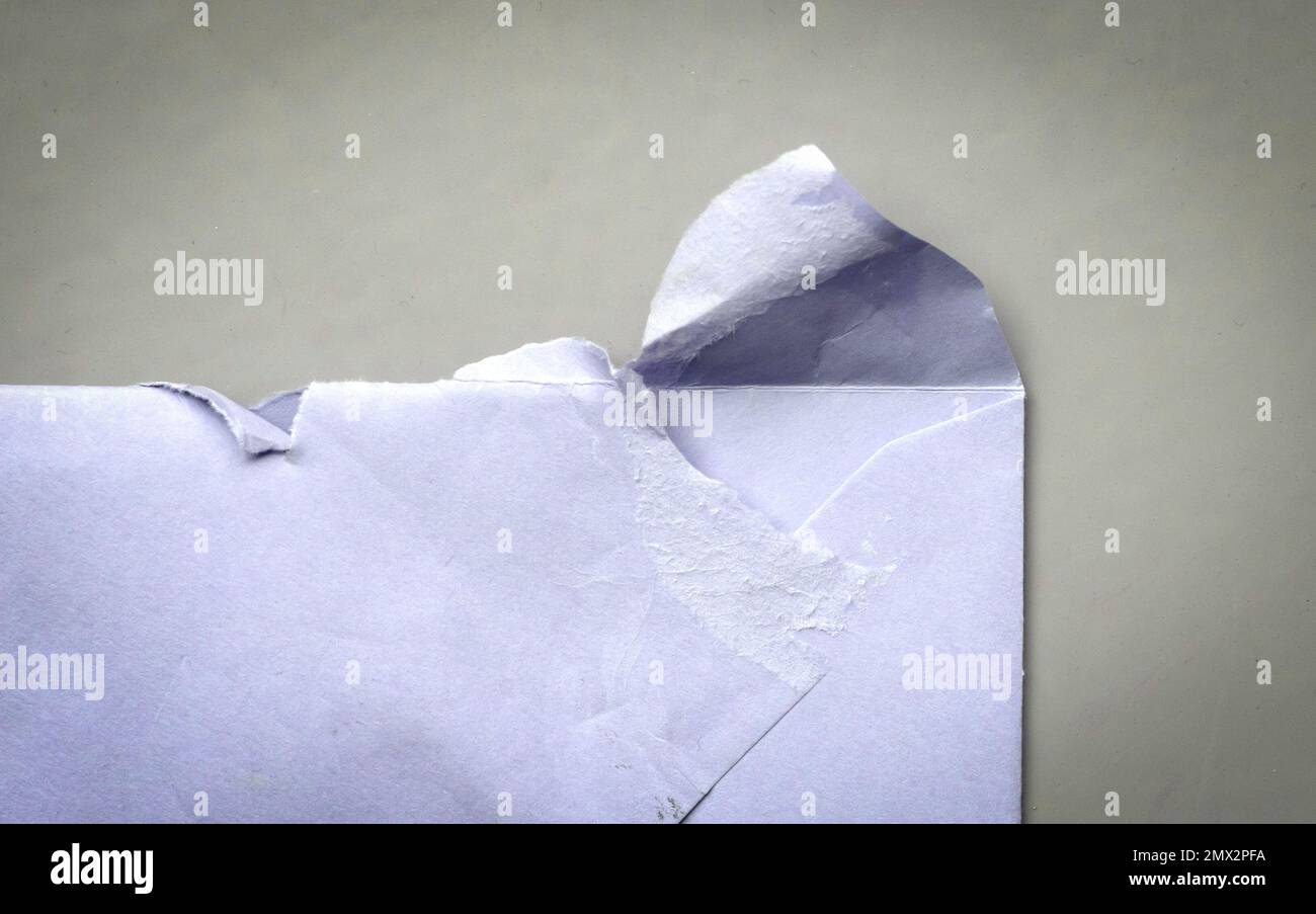 Torn (opened) envelope on a grey background Stock Photo - Alamy