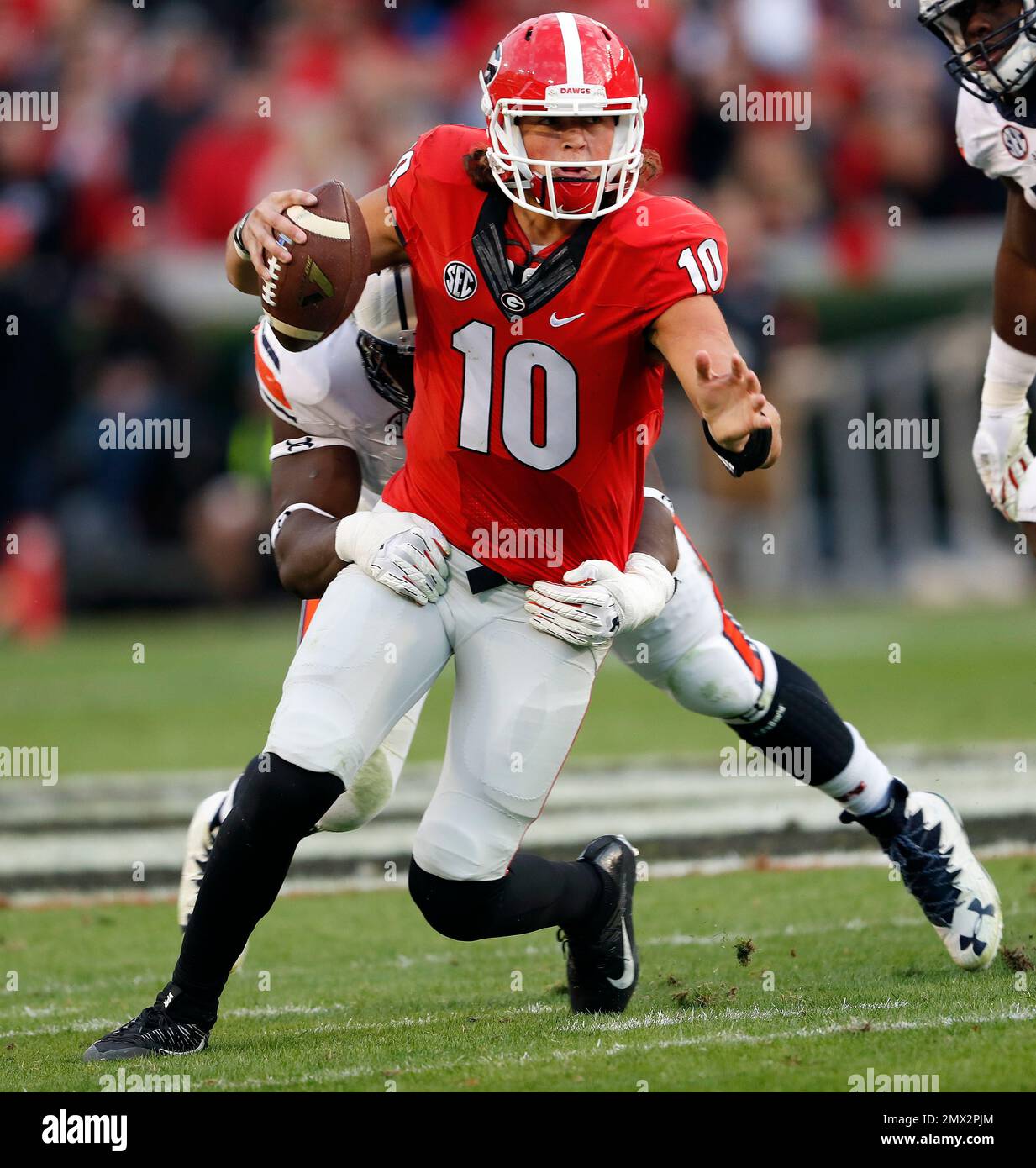 Georgia quarterback Jacob Eason (10) is brought down by Auburn ...