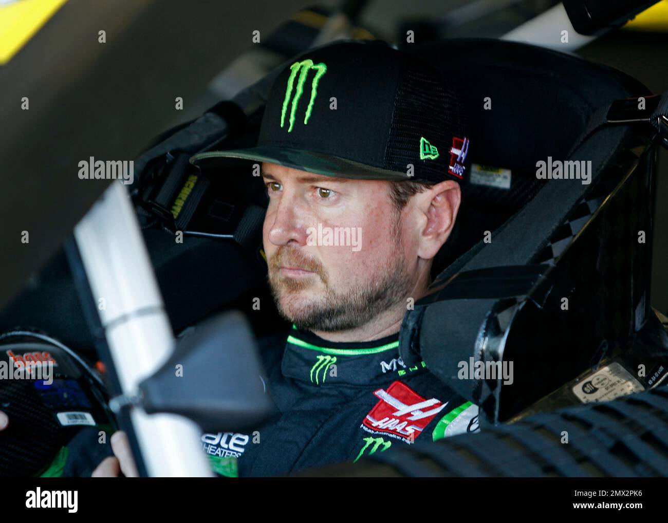 Kurt Busch sits in his race car before practice for the NASCAR Sprint ...