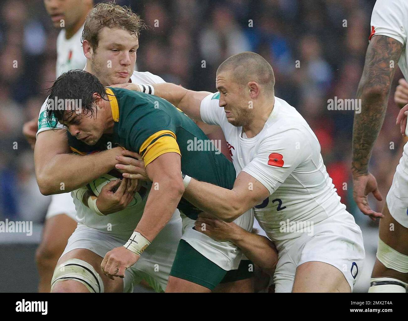 South Africa's Francois Venter, centre, is tackled by England's Mike ...
