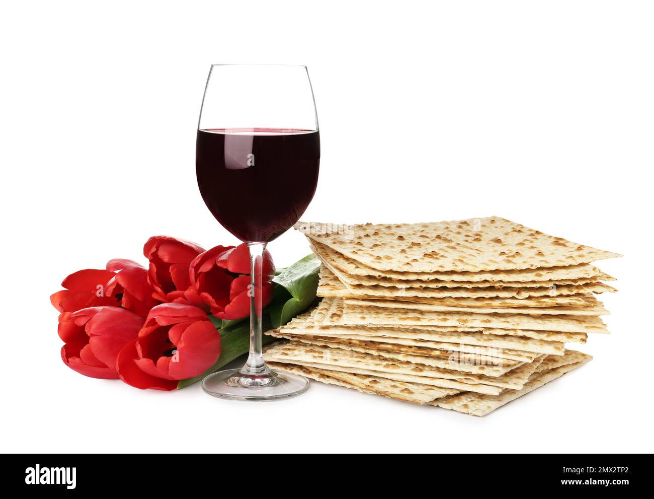 Passover matzos, glass of wine and flowers on white background. Pesach ...