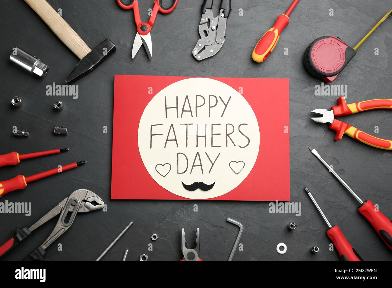 Card with phrase HAPPY FATHER'S DAY and different tools on stone ...