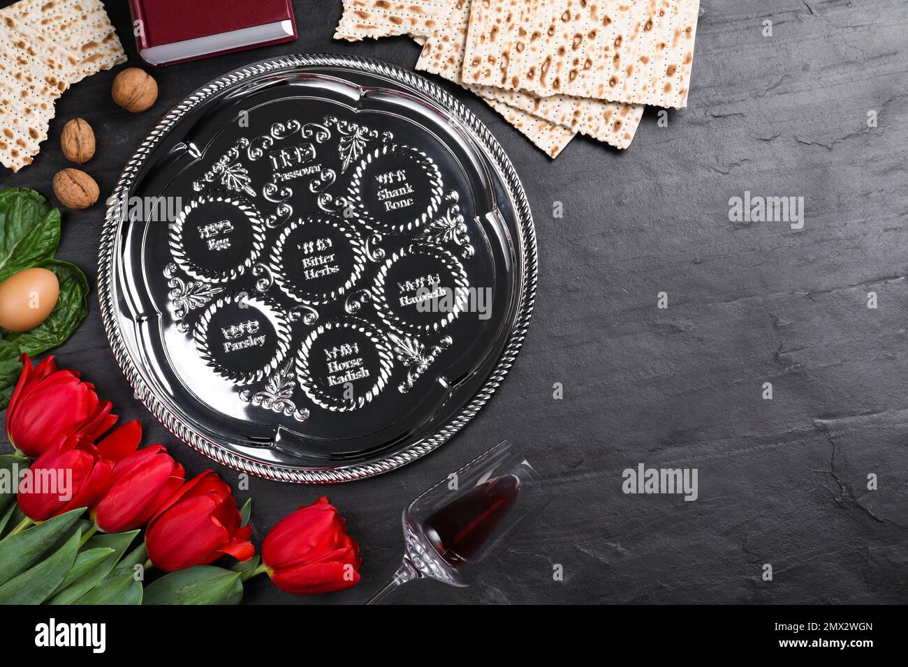Flat lay composition with Passover Seder plate (keara) on black table ...
