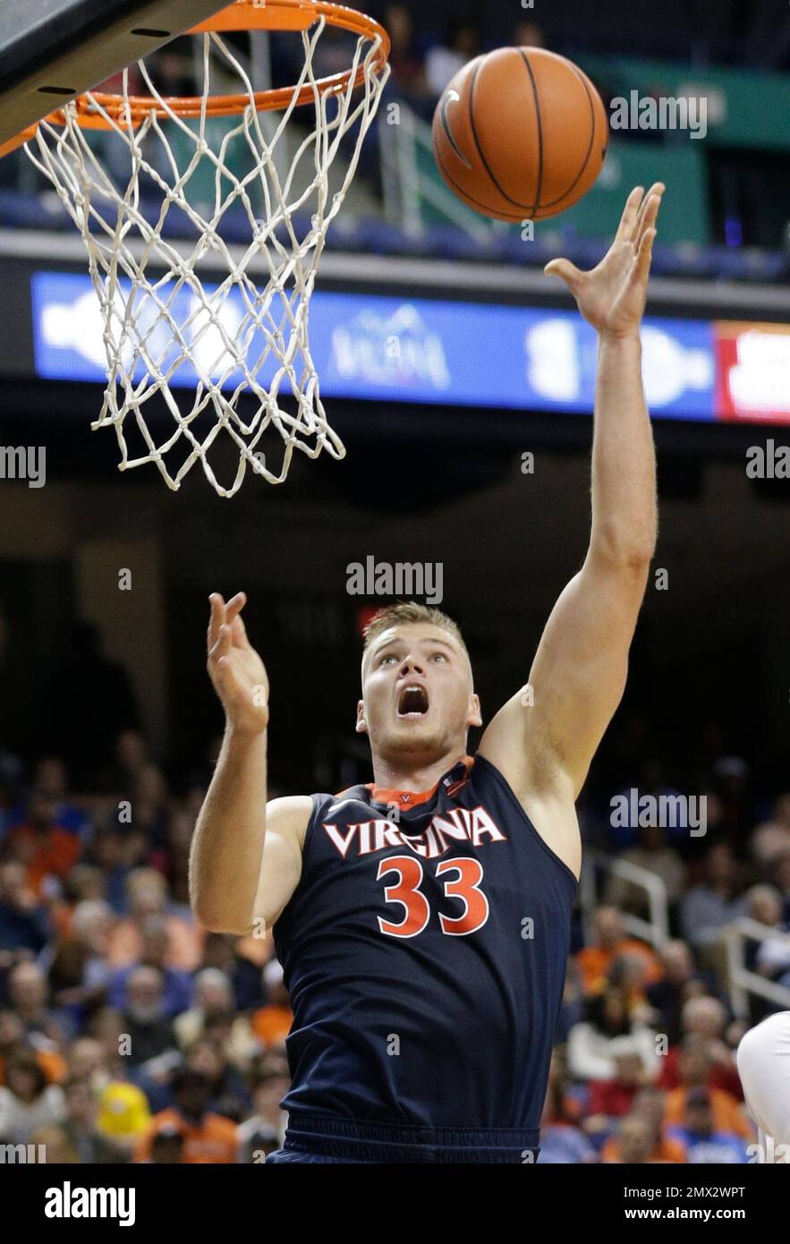 Virginia's Jack Salt (33) shoots against UNC Greensboro in the first ...