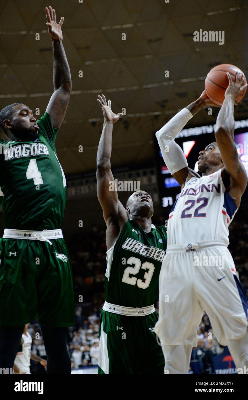Connecticut's Terry Larrier, right, shoots as Wagner's AJ Sumbry, left ...