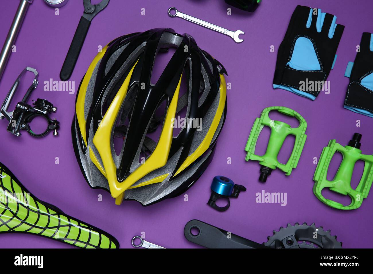 Set of different bicycle tools, accessories and parts on purple ...
