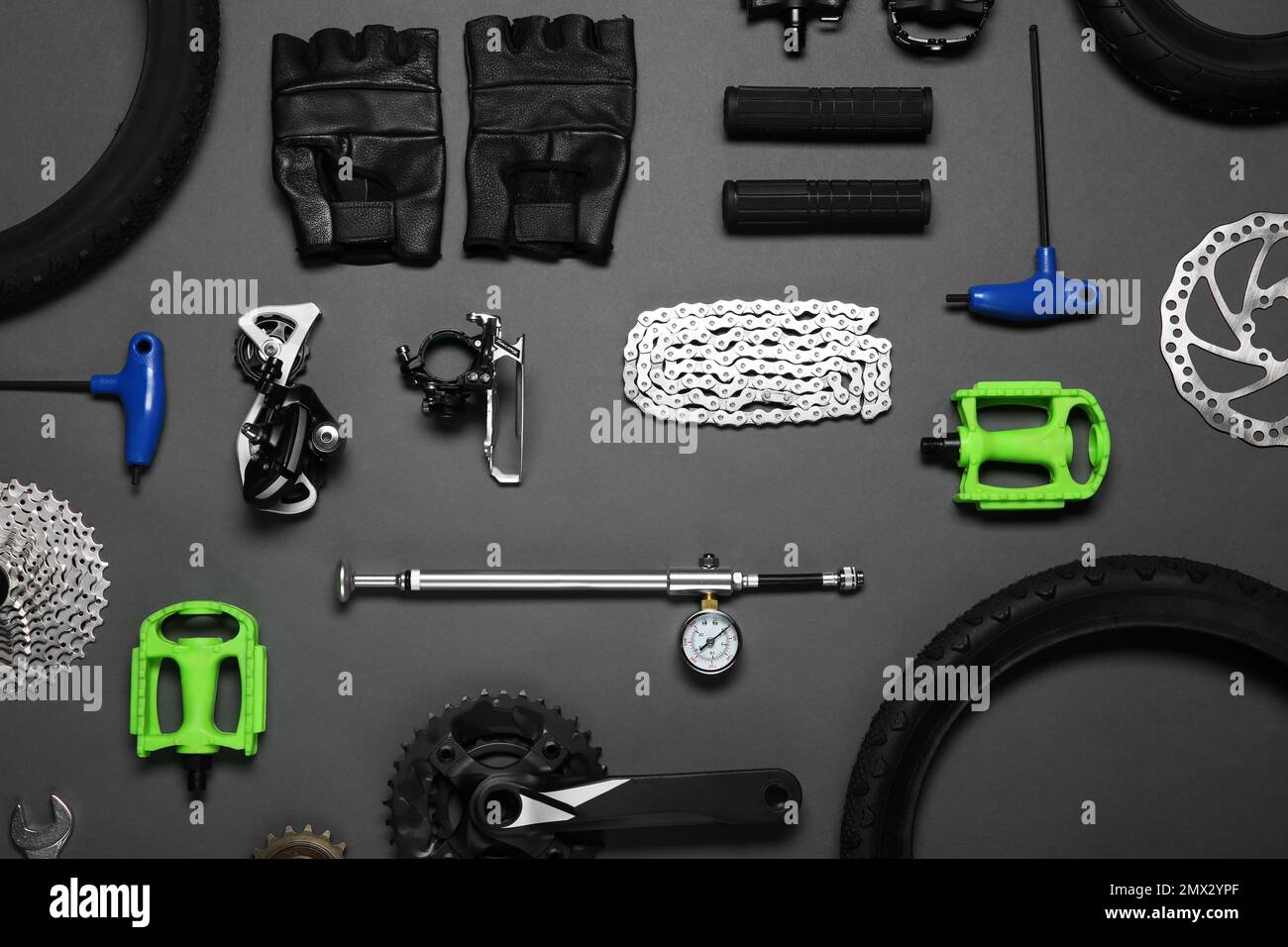Set of different bicycle tools and parts on grey background, flat lay ...