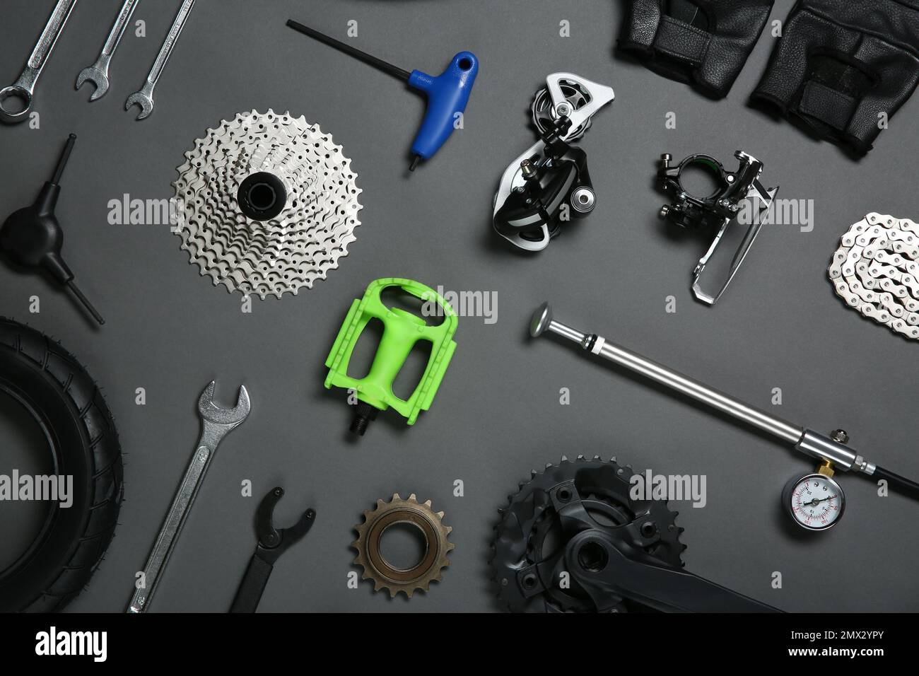 Set of different bicycle tools and parts on grey background, flat lay ...