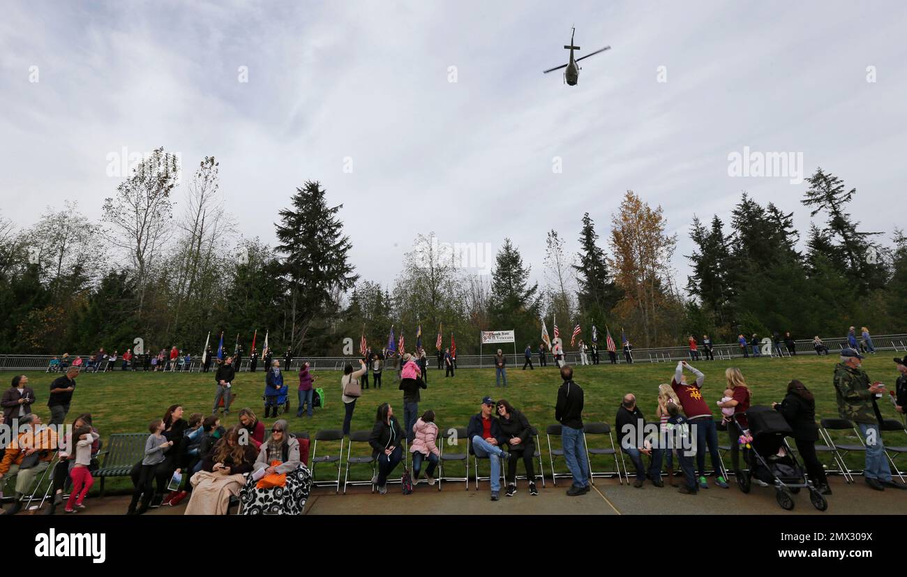 Audience members watch as a King County Sheriff's Department helicopter ...