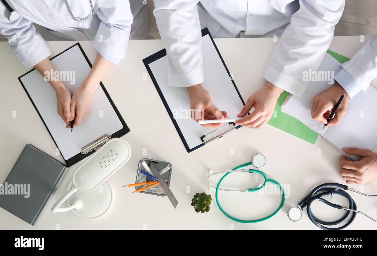 Doctors having meeting at table in office, top view Stock Photo - Alamy