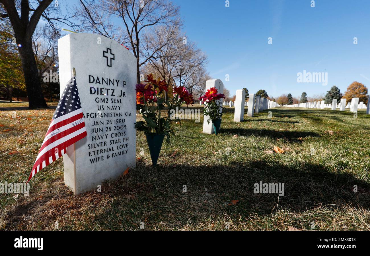 An American flag and flowers flank the grave of United States Navy SEAL ...