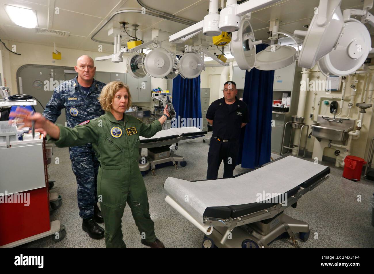 In this April 14, 2016, Navy doctor Kim Toone, front, gestures in an ...