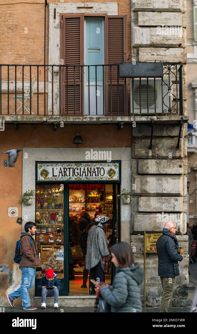 people in a craft and souvenir shop in the city center. rome, italy ...