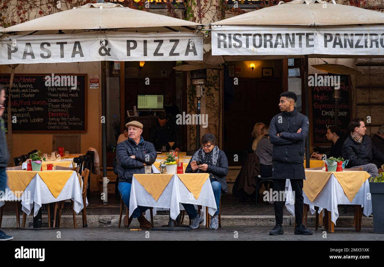 adult couple sitting making an aperitif in a typical traditional Roman ...