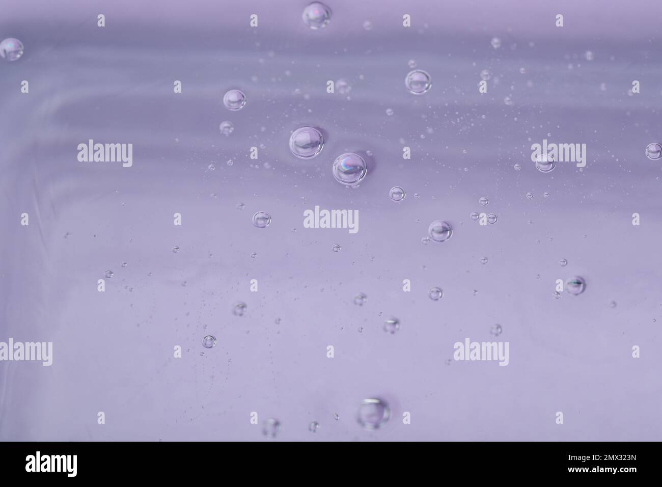 Pure transparent cosmetic gel on lilac background, closeup Stock Photo ...