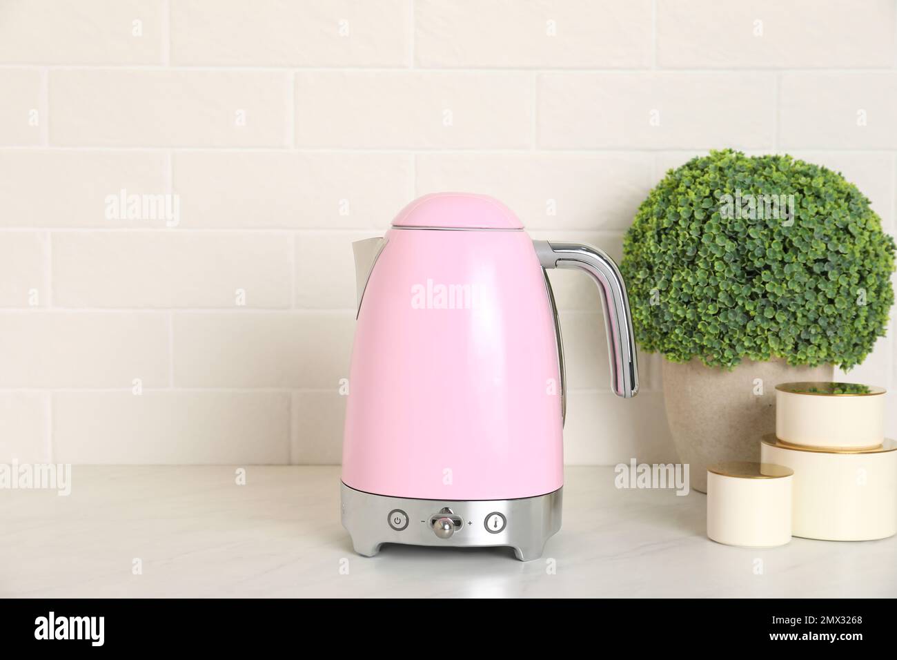 Modern electric kettle on counter in kitchen Stock Photo - Alamy