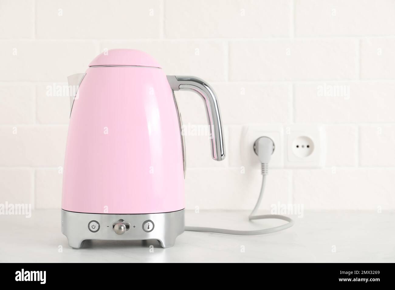 Modern electric kettle on counter in kitchen Stock Photo - Alamy
