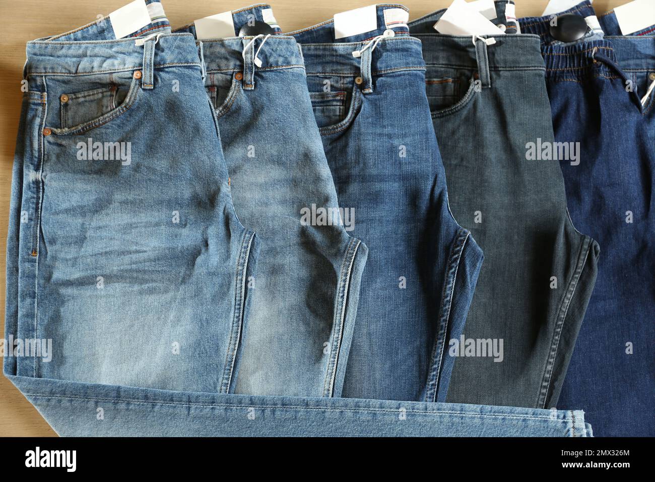 Modern blue jeans on display in shop, top view Stock Photo - Alamy