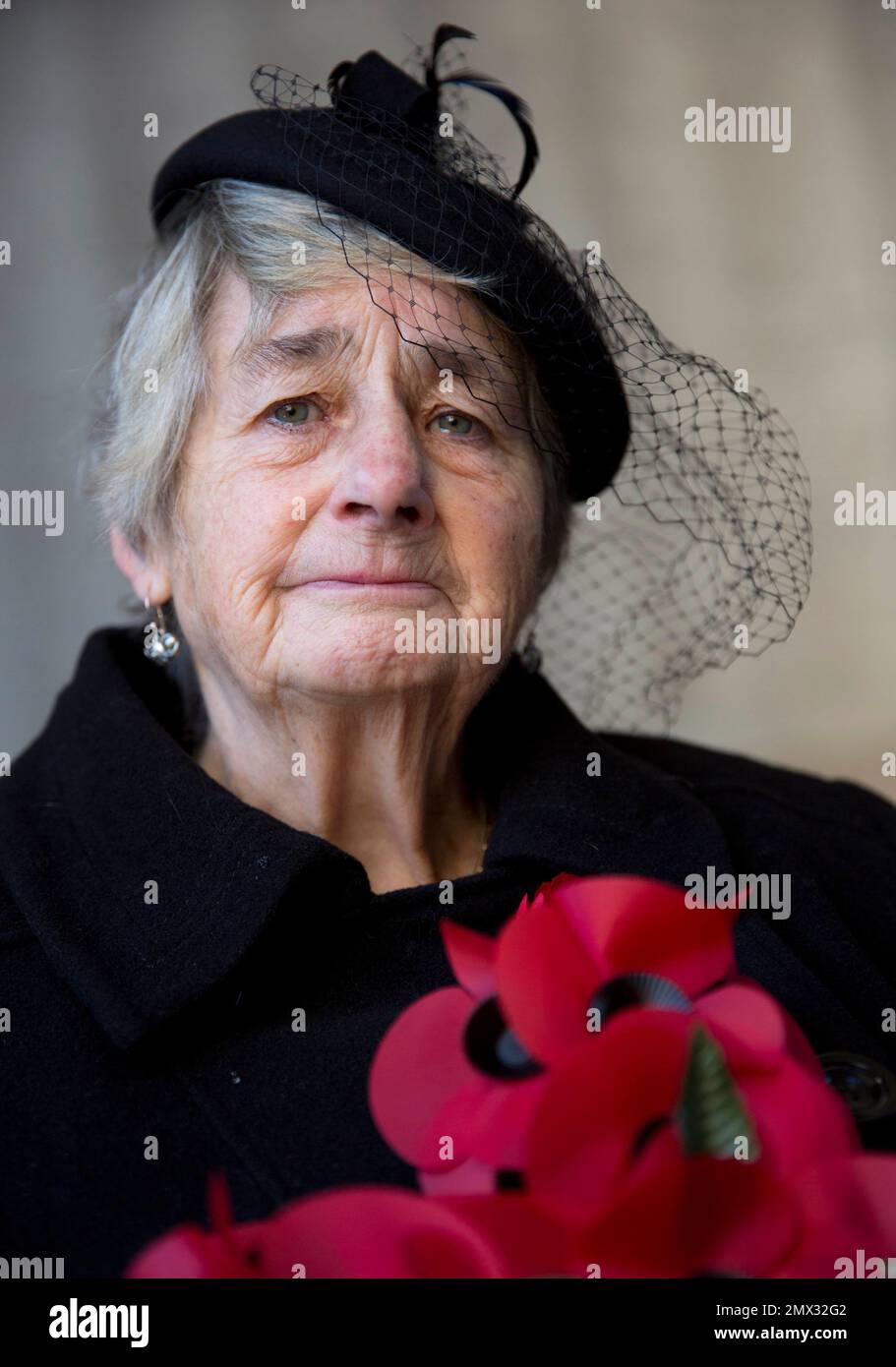 Francesca Shaw, from Leeds, England, holds a poppy wreath during an ...