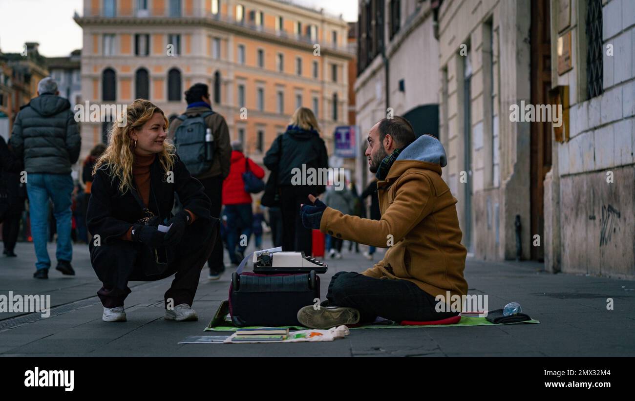 street artist talking to a tourist. street writer in rome, italy. city ...
