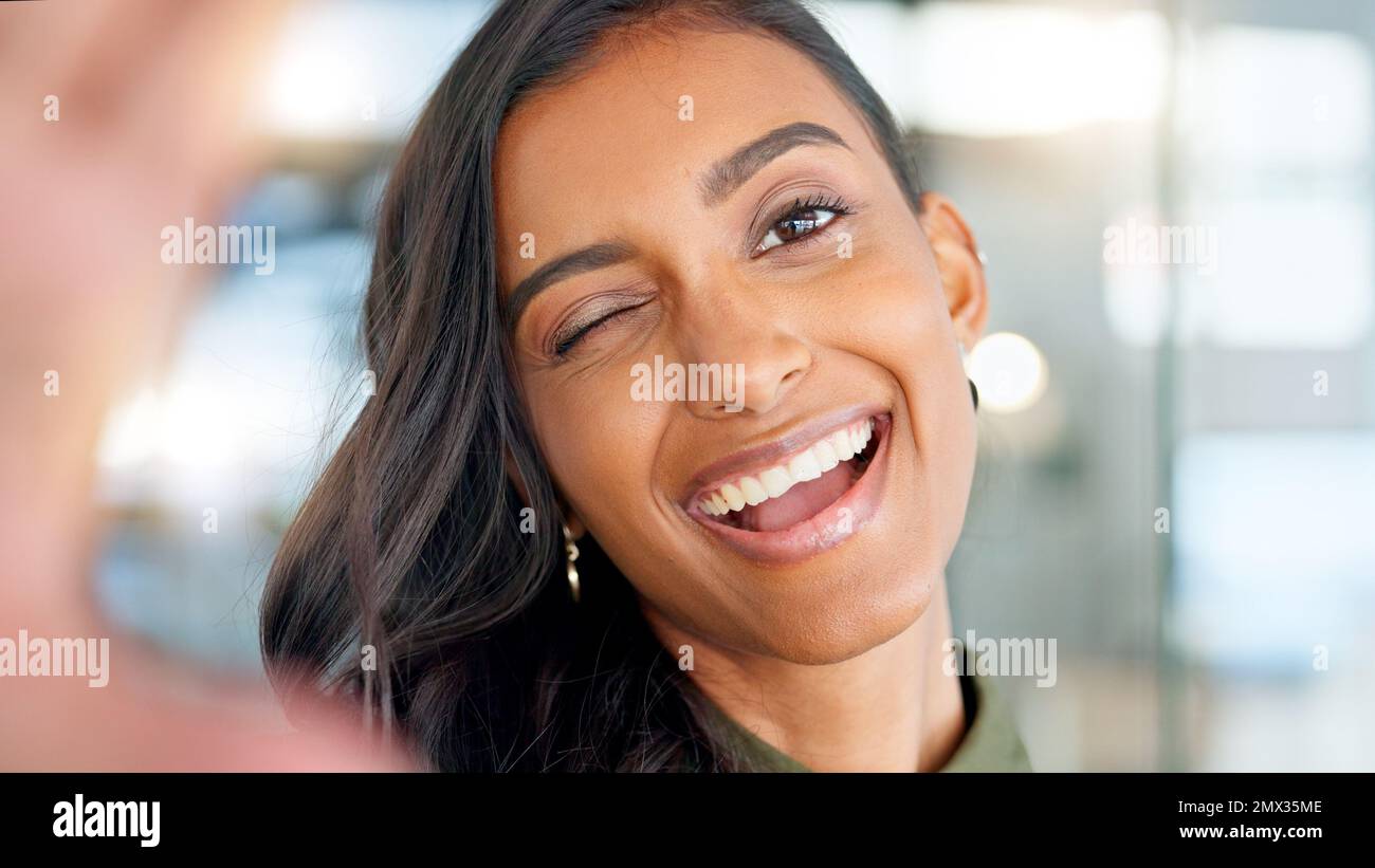 Smiling, beautiful and fresh female face winking feeling fun, silly and ...