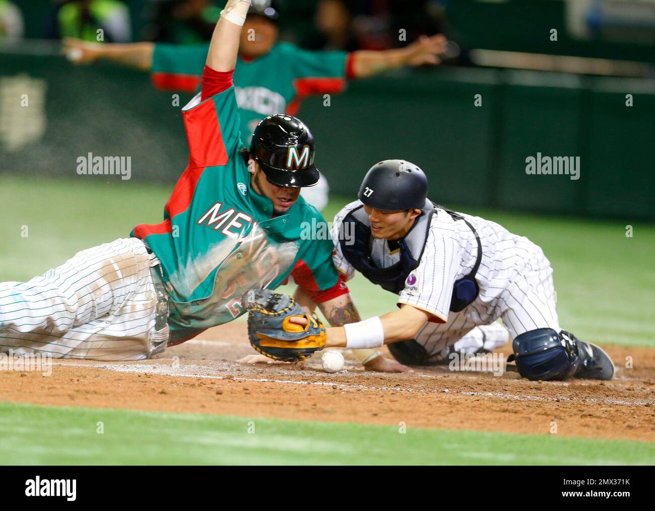 Mexico's Sebastian Valle, left, scores a run as Japan's catcher Shota ...