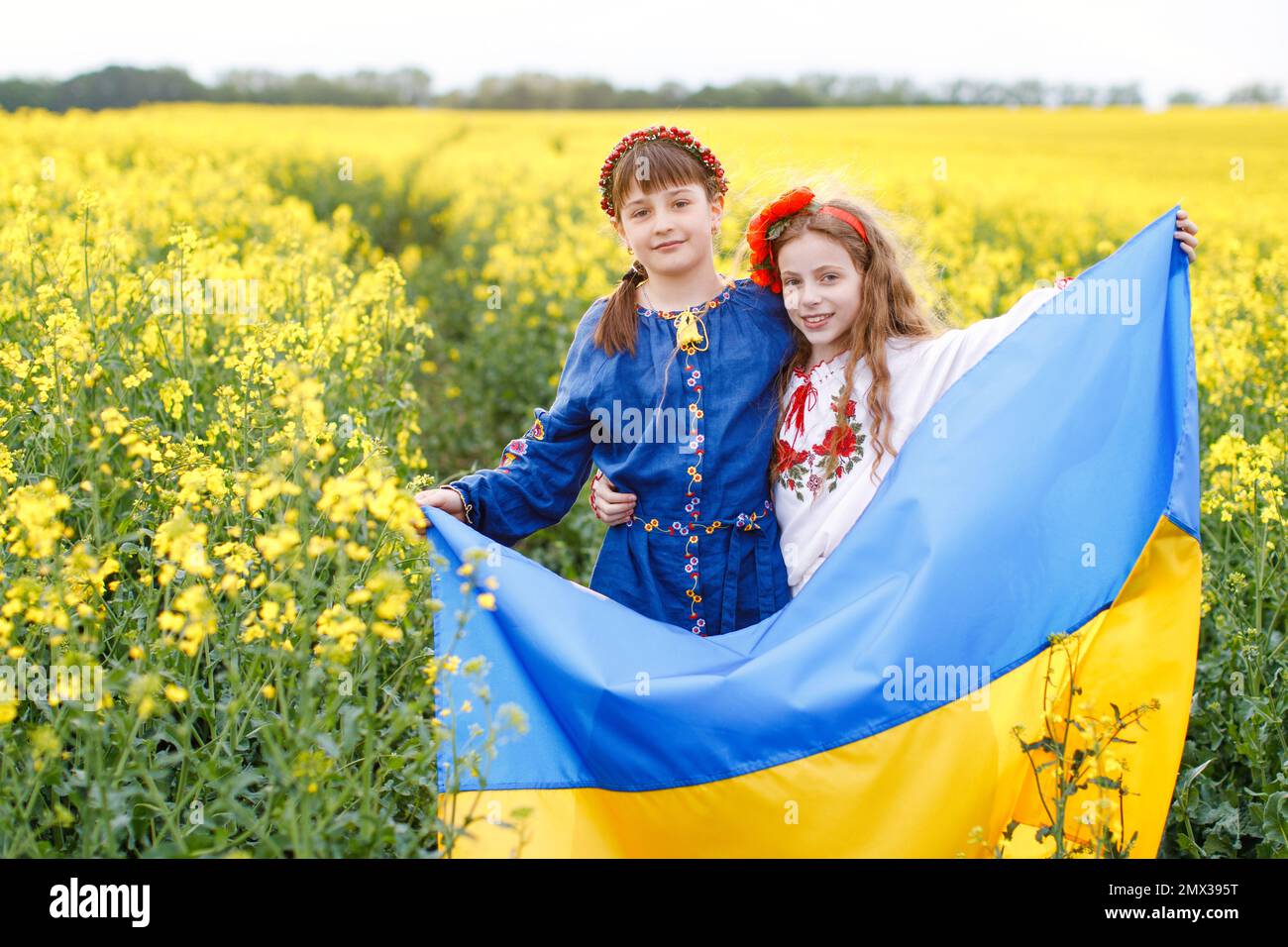 Pray for Ukraine. Two cute girls holding in hands a blue and yellow ...