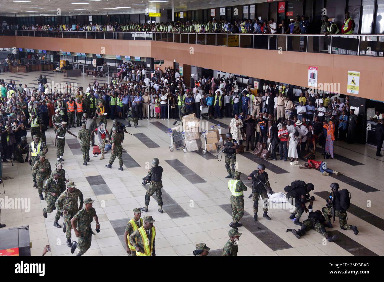 People and passengers watch Nigerian Air Force special unit conduct a ...