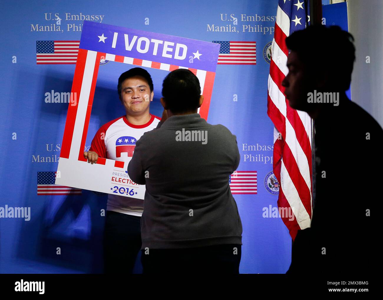 A Filipino student poses for a free souvenir photo after casting his ...