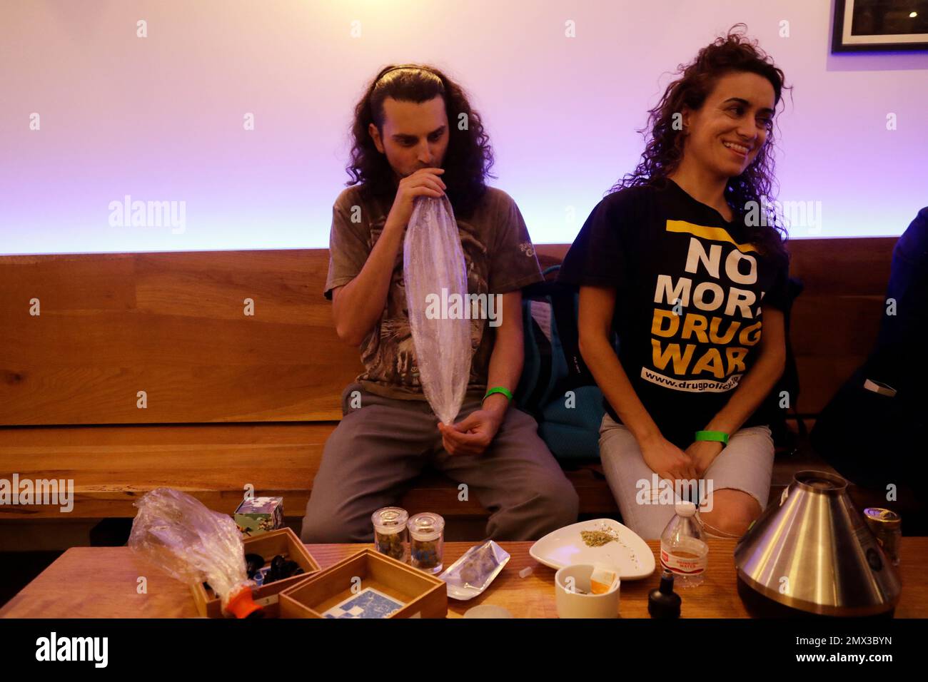 Dominic Ripoli, left, and Bella Yousif smoke marijuana at a rally in ...