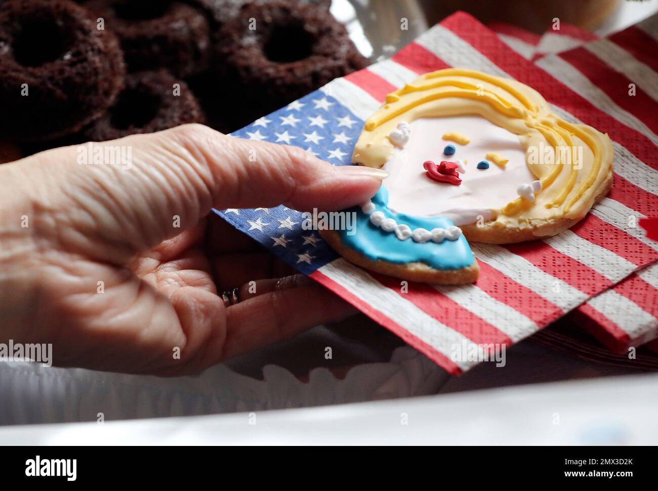 A guest picks up a cookie depicting Democratic presidential nominee ...