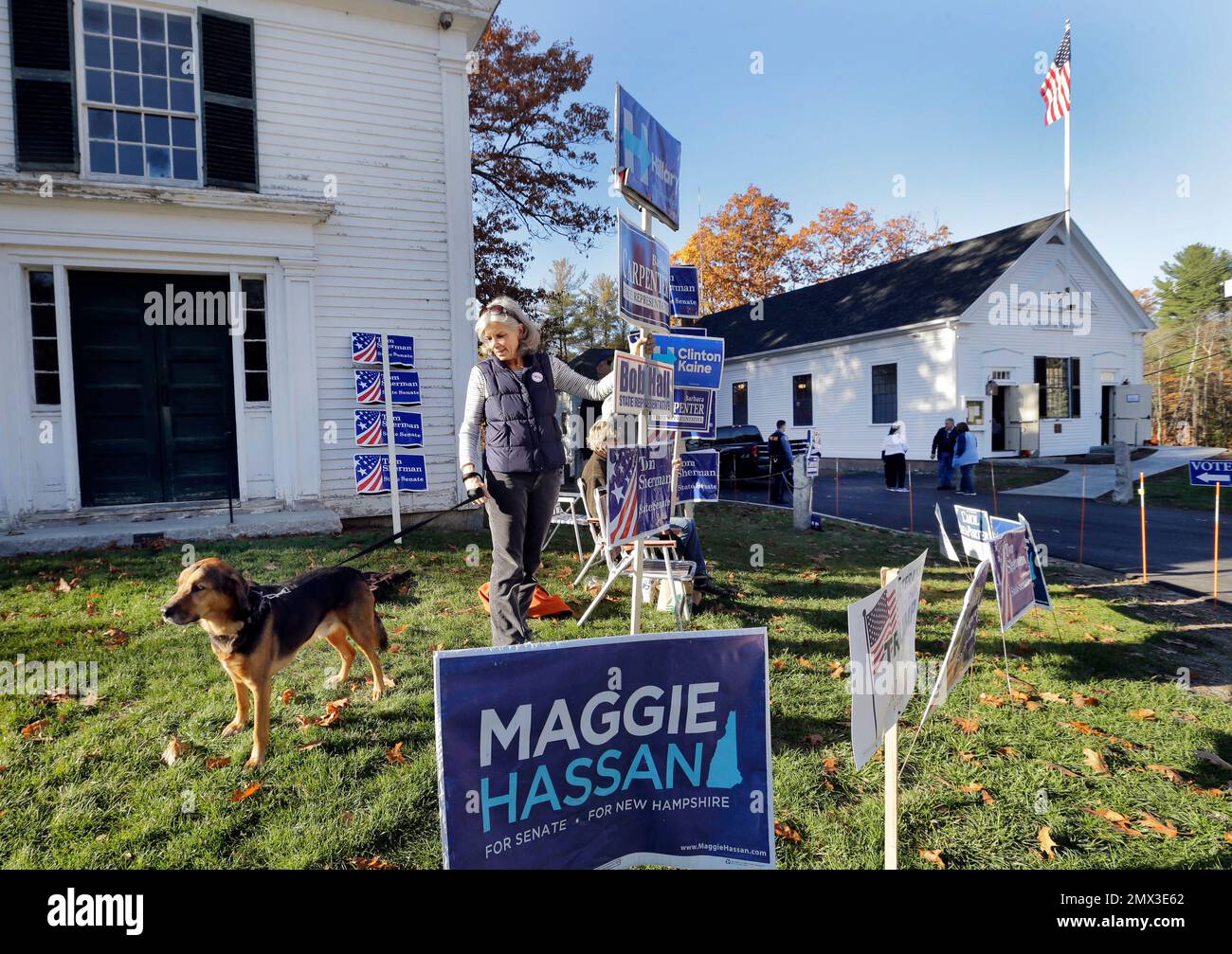 Susan Varn holds campaign signs while keeping an eye on her dog, Sam ...