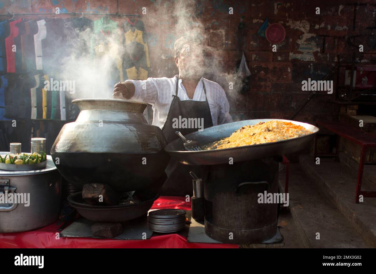 A road side food vendor prepares Biriyani, a mixed rice dish near Jama ...