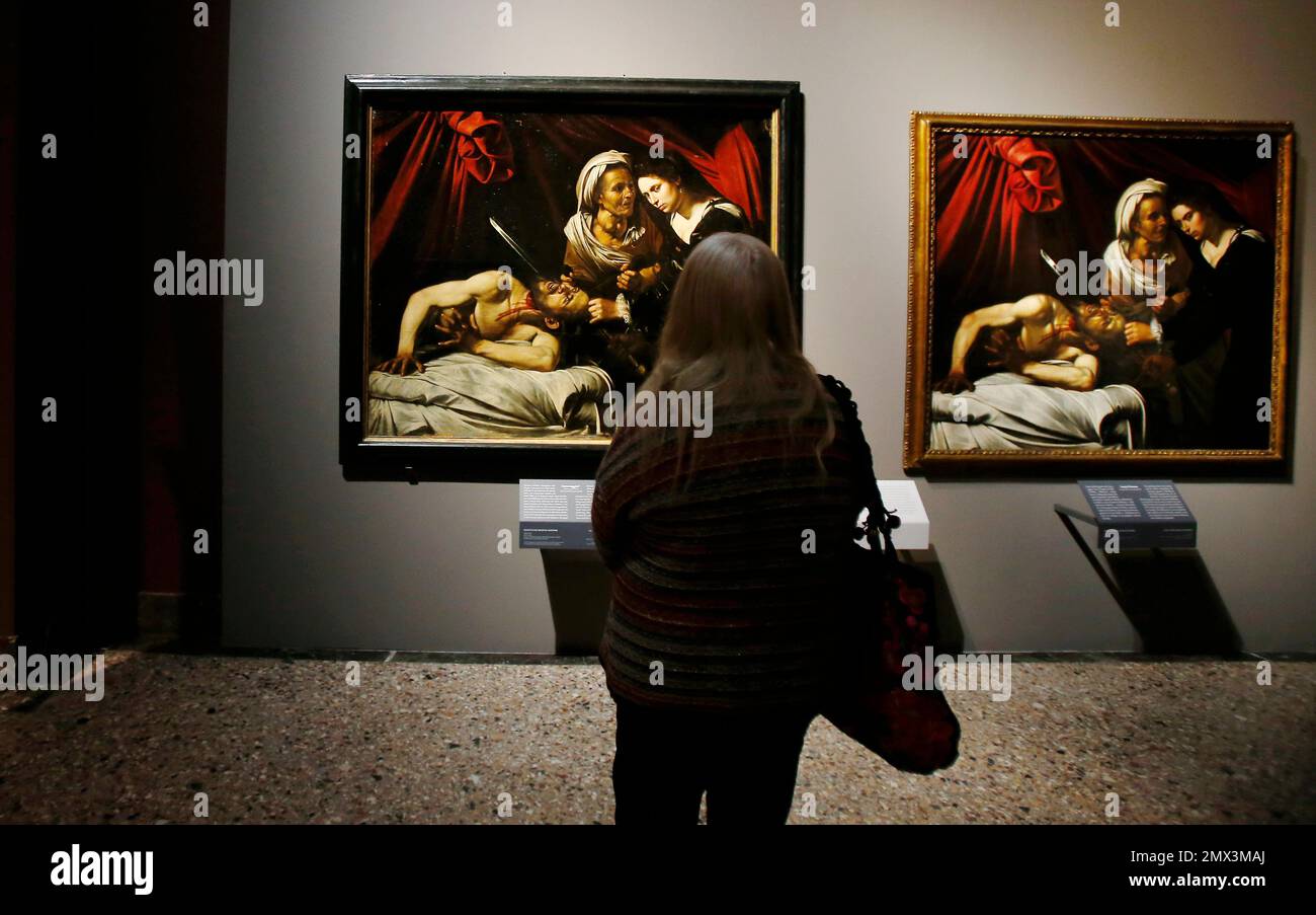 A woman looks at a painting believed to be the "Judith Beheading ...
